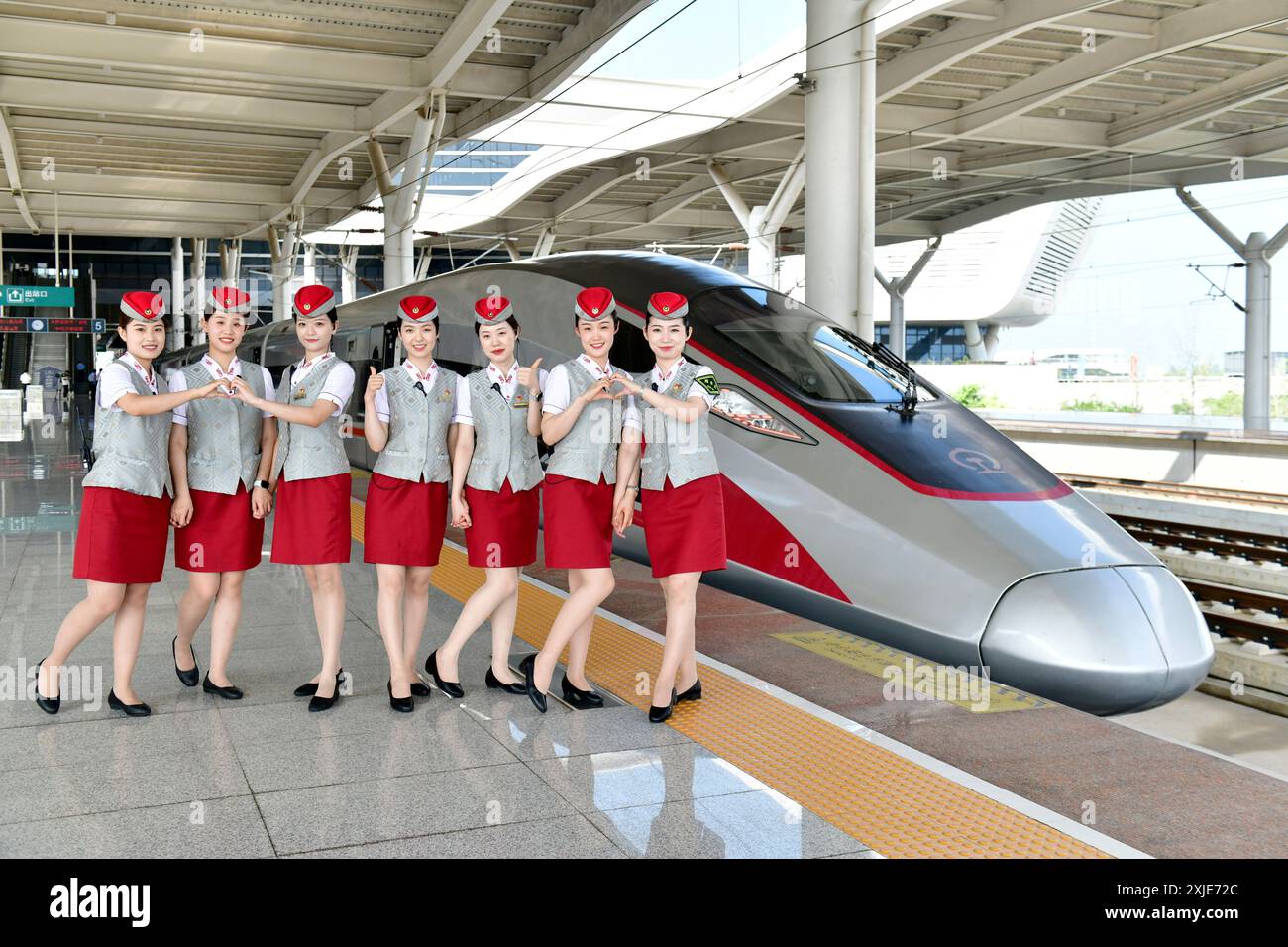 (240718) -- HEZE, July 18, 2024 (Xinhua) -- Train attendants pose for a ...