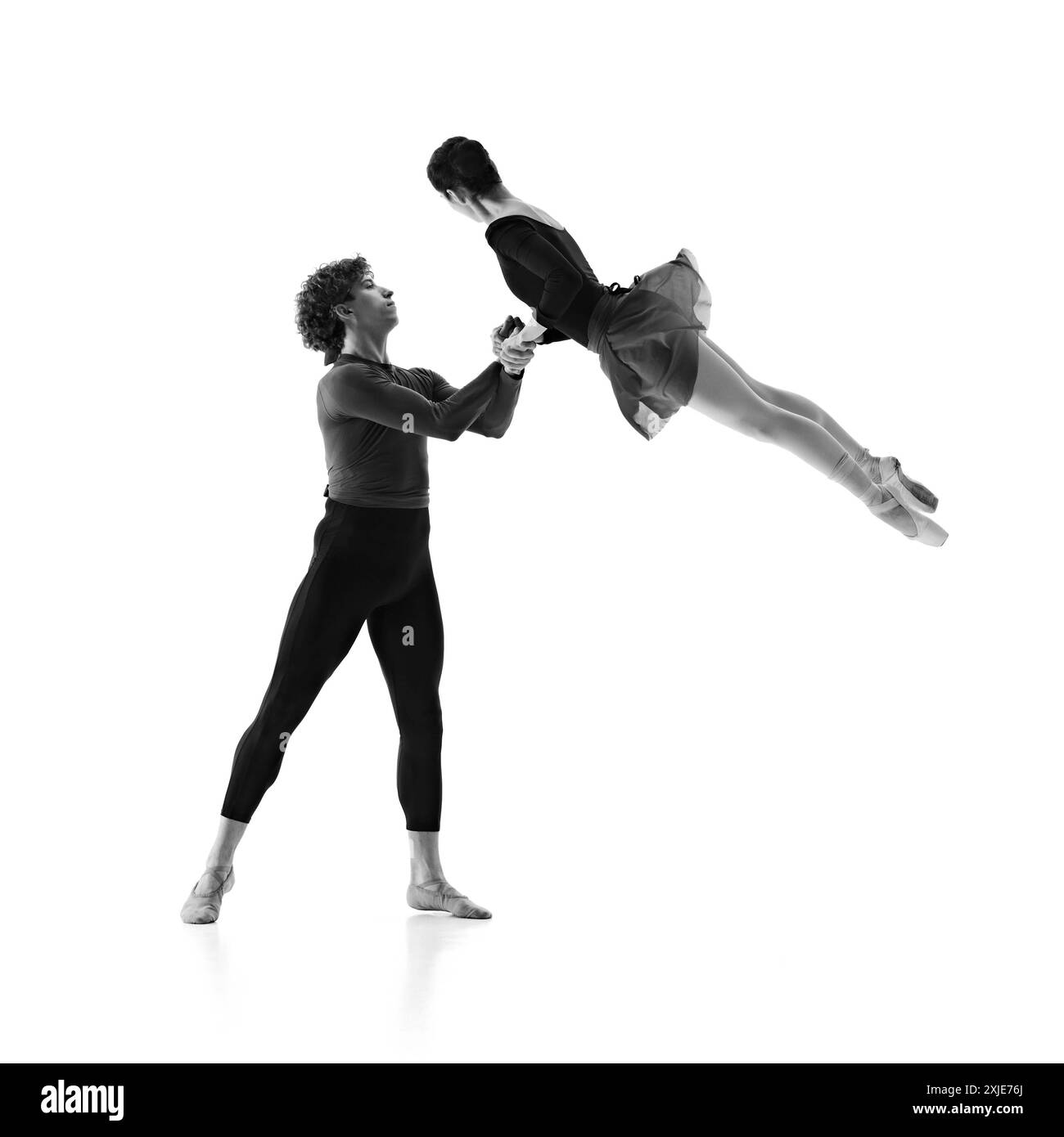 Ballet partners in practice. Dancer lifts ballerina in motion against ...