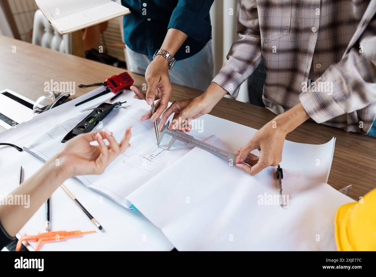 Collaborative Engineers Working on Architectural blueprint and ...
