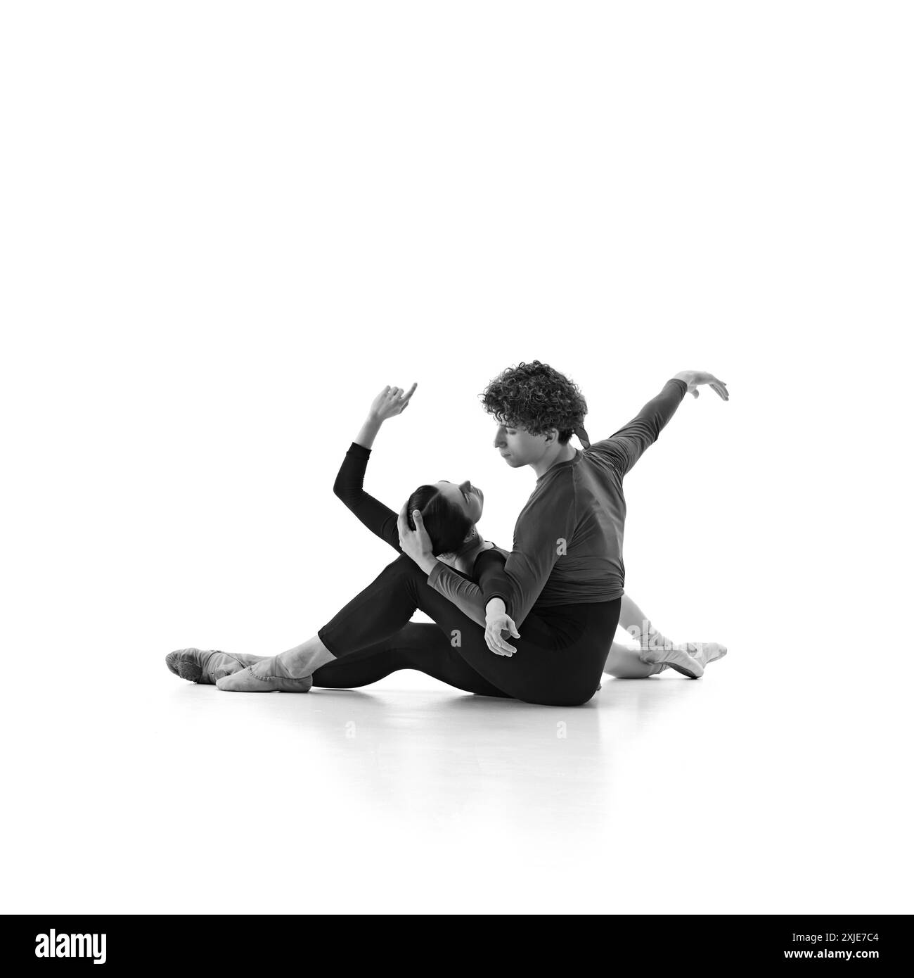 Ballet partners intertwine gracefully on floor shows connection and ...