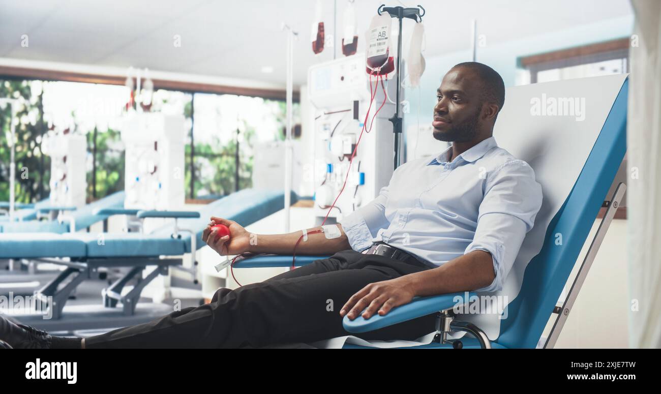 Black Man Donating Blood For People In Need In Bright Hospital. African ...