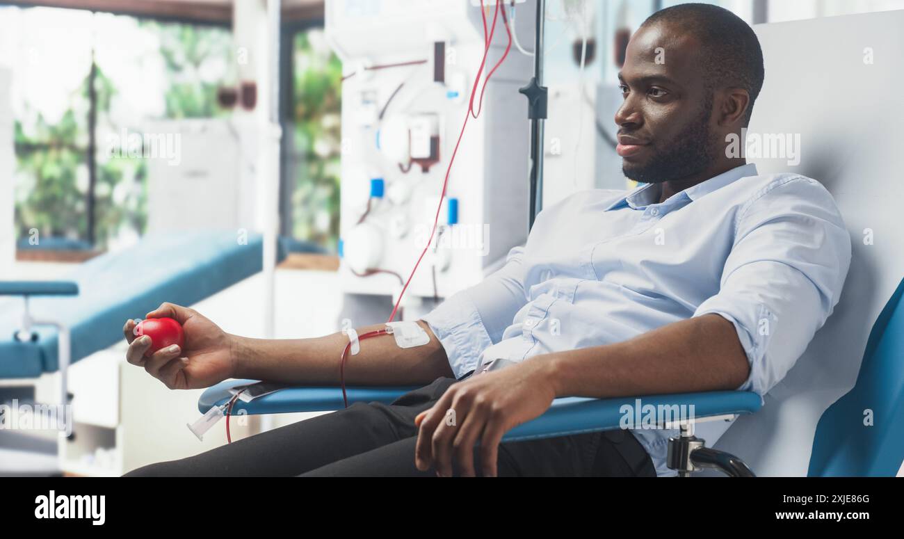 Black Man Donating Blood For People In Need In Bright Hospital. African ...
