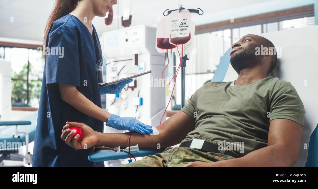Caucasian Female Nurse Taking Blood Donation From Black Army Troop In ...