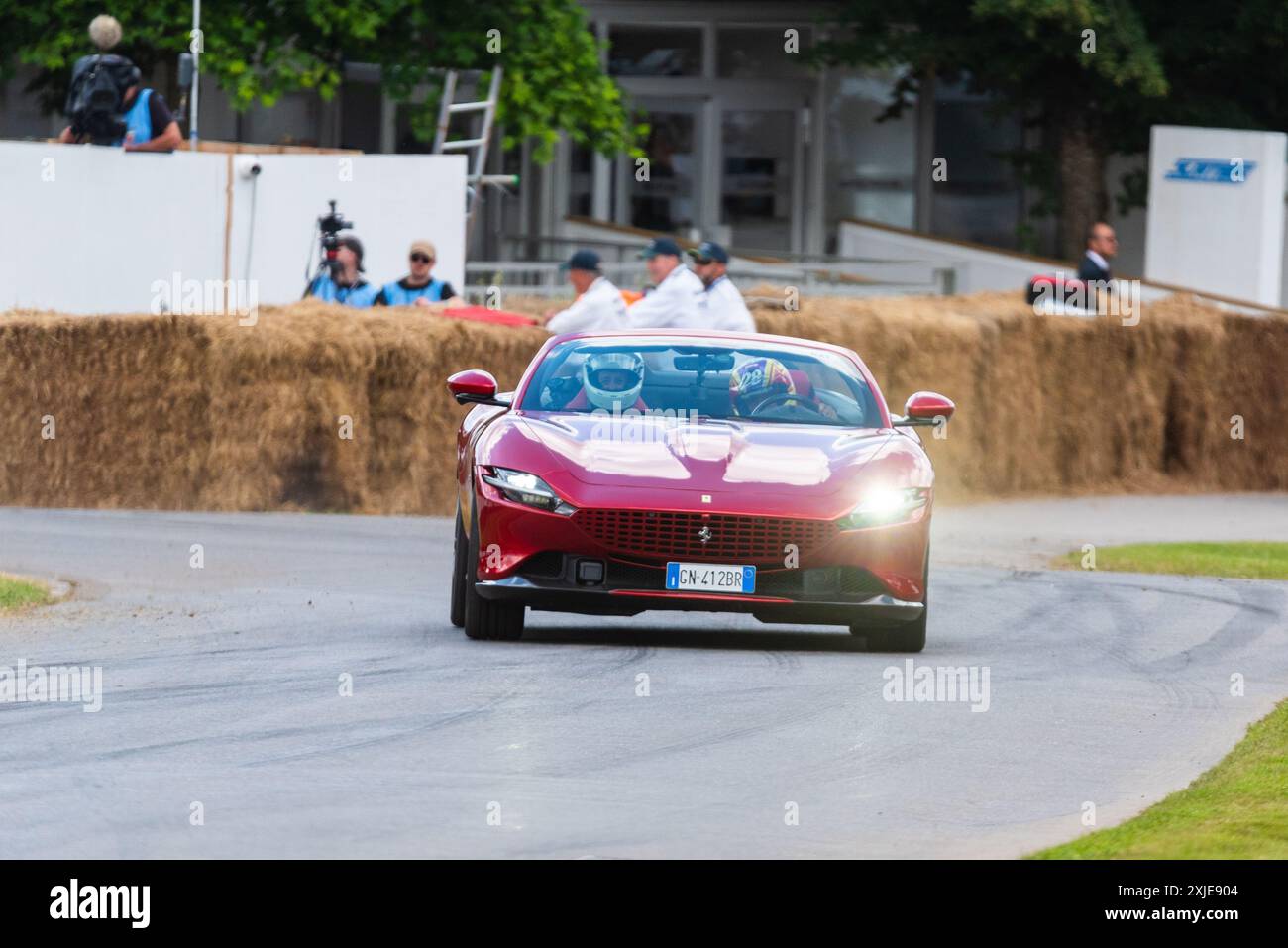 2024 Ferrari Roma Spider soft top gt car driving up the hill climb track at the Goodwood ...