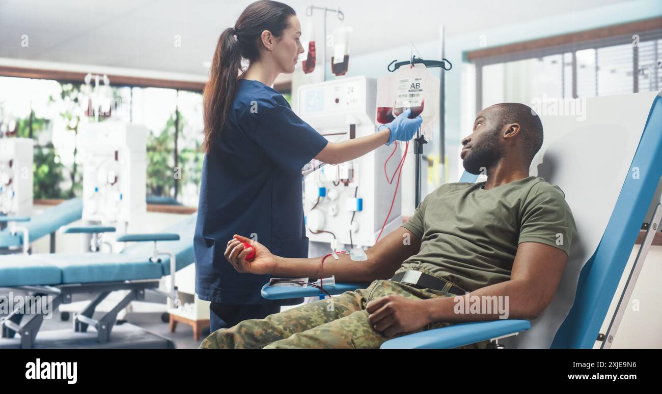 Caucasian Female Nurse Taking Blood Donation From Black Army Troop In ...