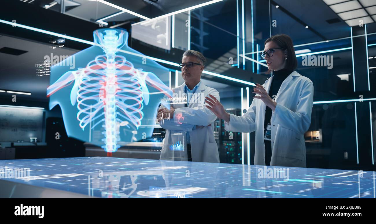 Two Bioengineers Working With Computer-Powered VFX Hologram Of Human ...