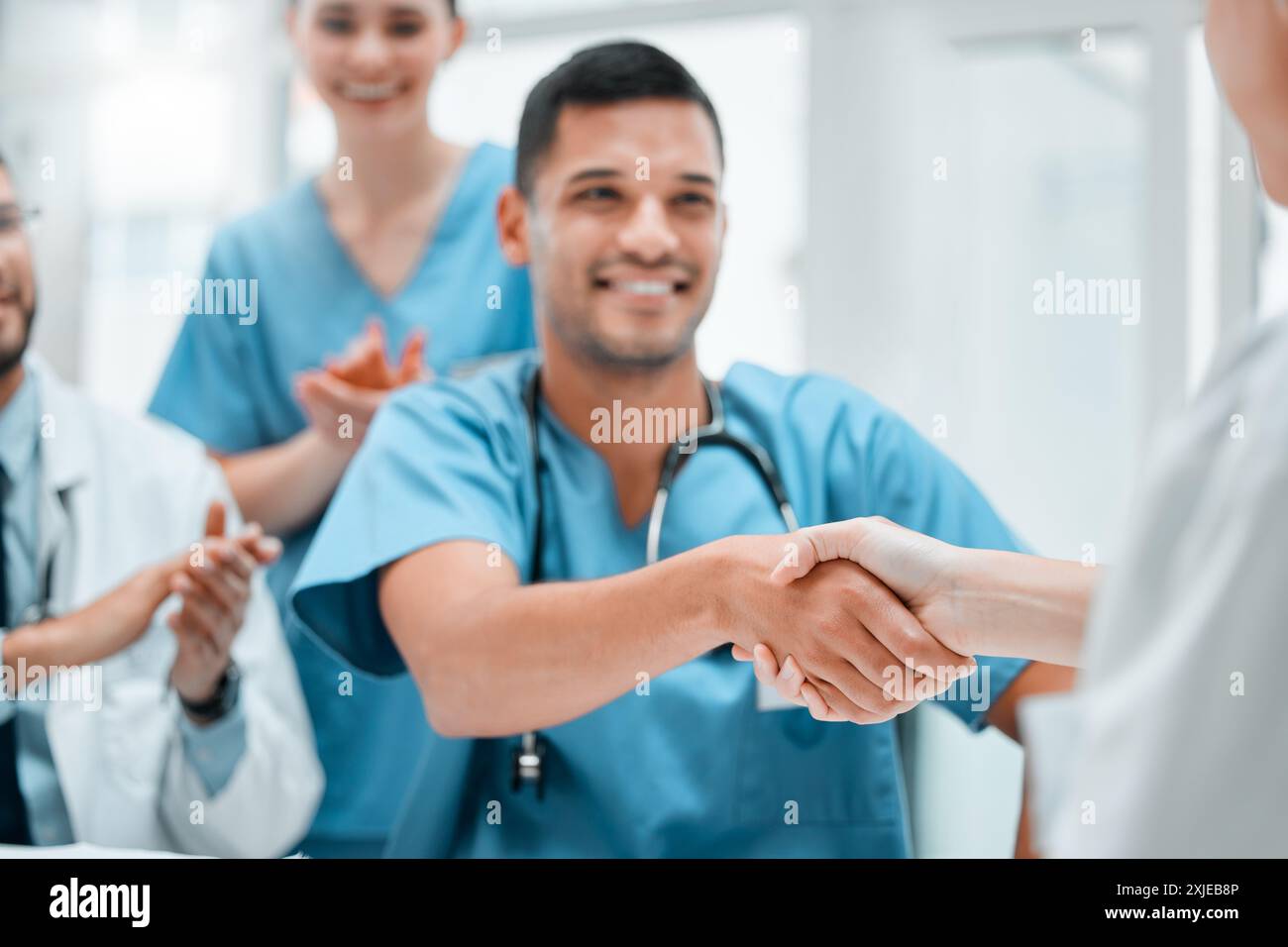 Doctor, handshake and thank you in hospital with applause, man and nurse achievement. Clinic ...