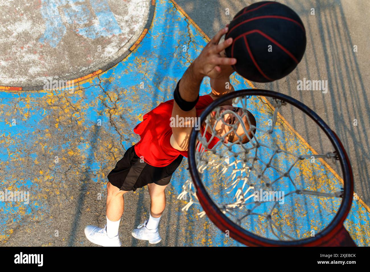 Top view of young man playing basketball outdoor. Slam dunk Stock Photo ...