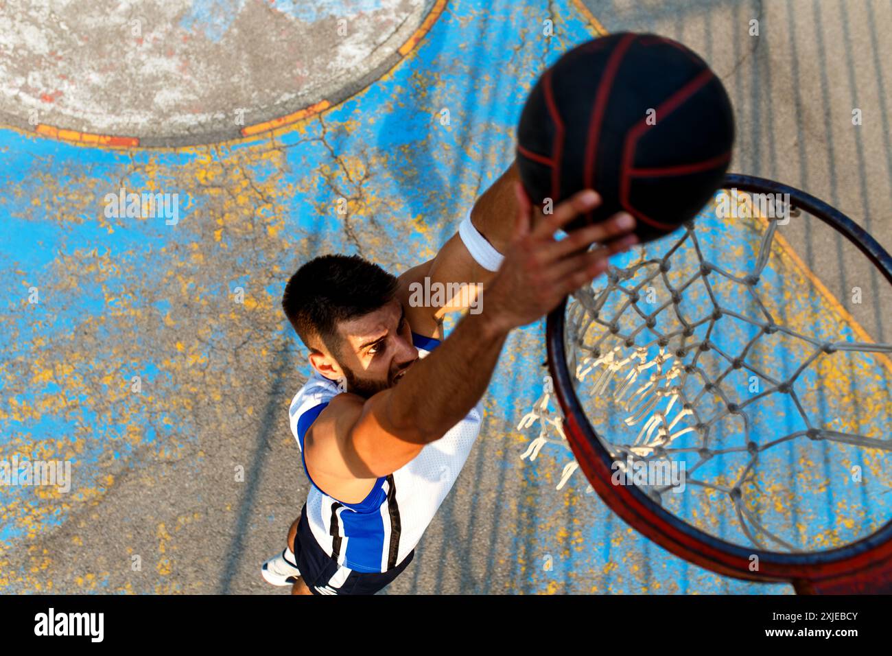 Top view of young man playing basketball outdoor. Slam dunk Stock Photo ...