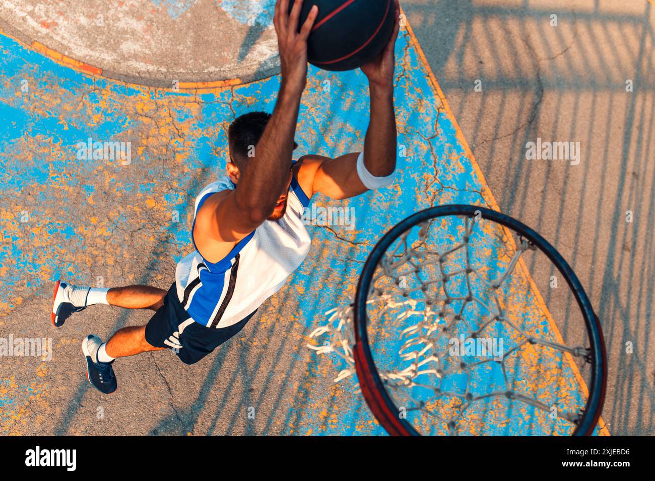 Top view of young man playing basketball outdoor. Slam dunk Stock Photo ...