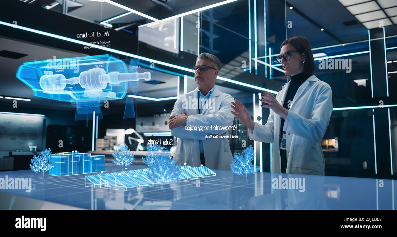 Male And Female Renewable Energy Engineers Using Futuristic Hologram of Wind Turbine Prototype ...