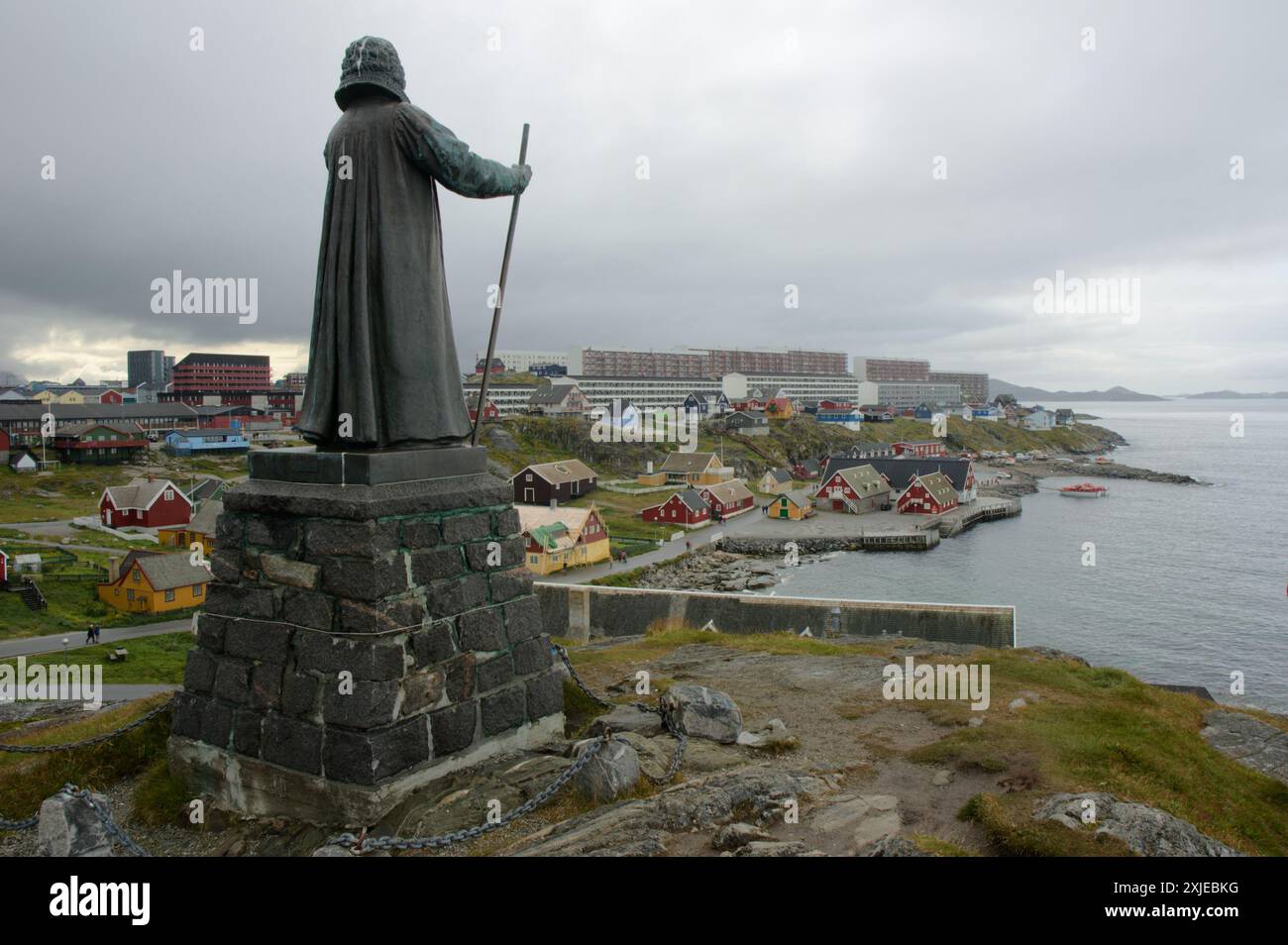 Statue of Hans Egede looks over the timber buildings of Old Nuuk ...