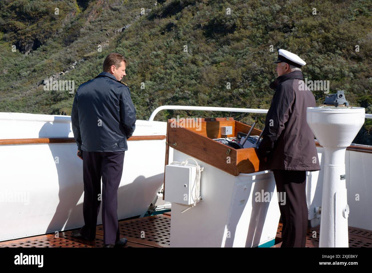 Officers on the bridge wing of cruise ship MV Discovery, bringing her ...