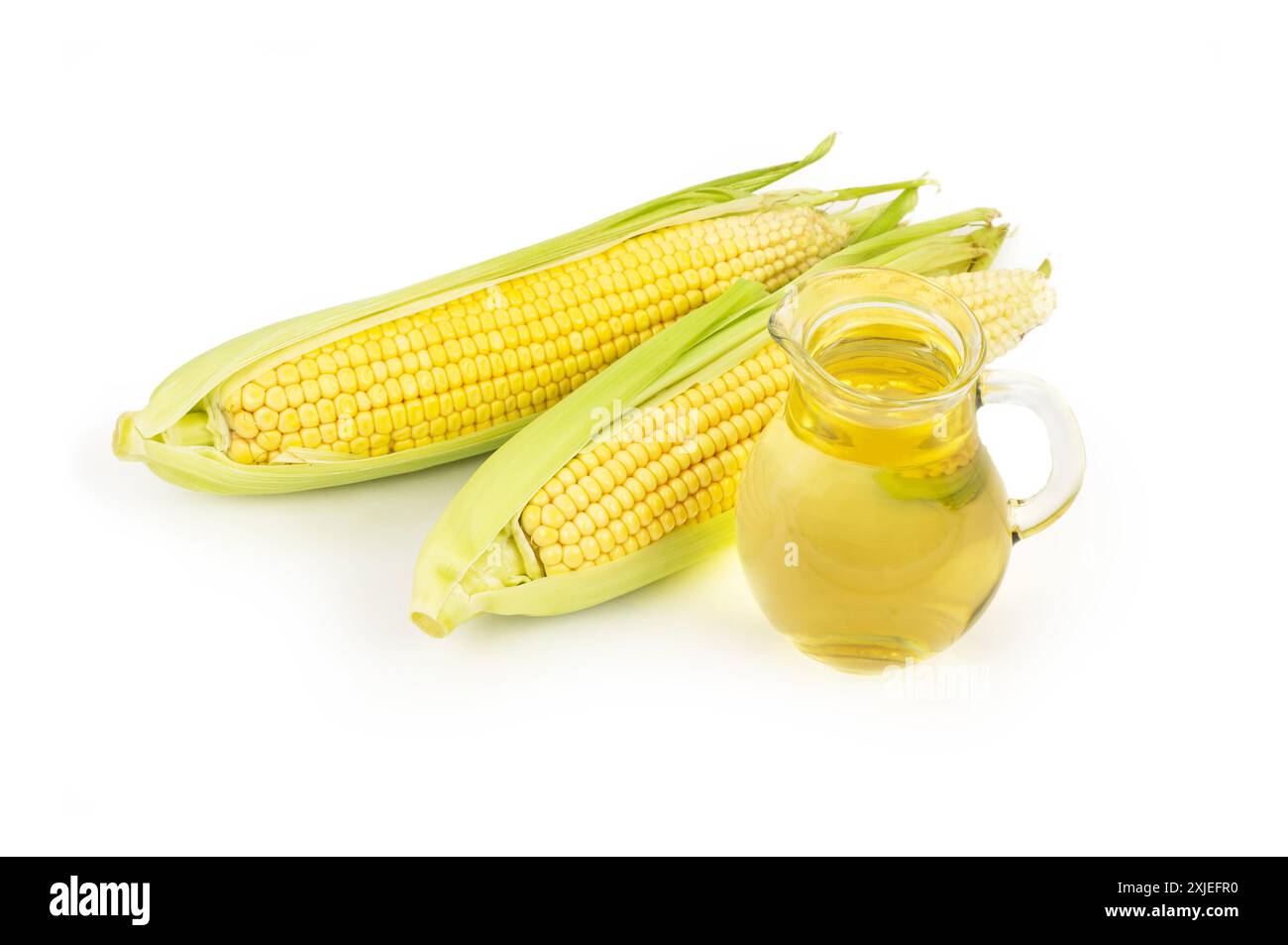 Corn oil in glass with fresh ripe corn cobs isolated on white ...