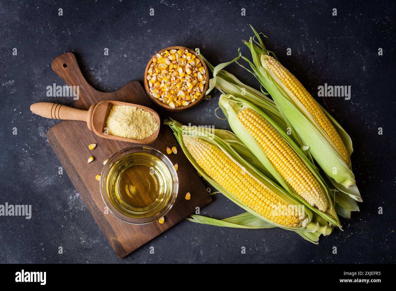 Corn oil and corn flour with fresh corncobs on rustic table, corn food ...