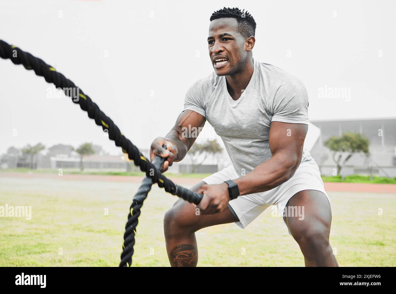 Battle rope, black man and fitness with workout for strong arm muscle ...