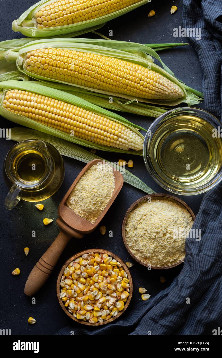Corn oil and corn flour with fresh corncobs on rustic table, corn food ...