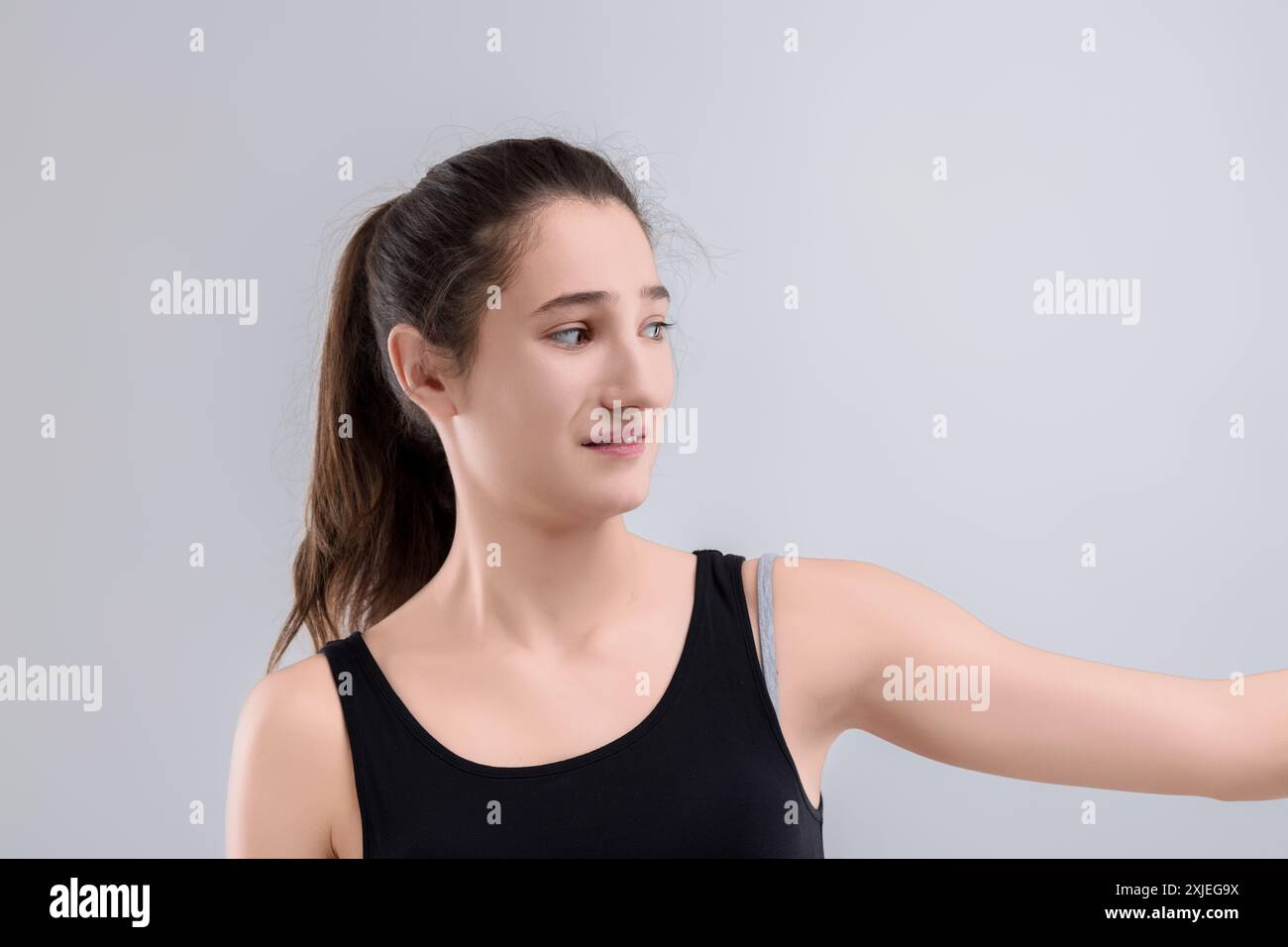 Disgusted young woman in a studio shot expresses rejection with a ...