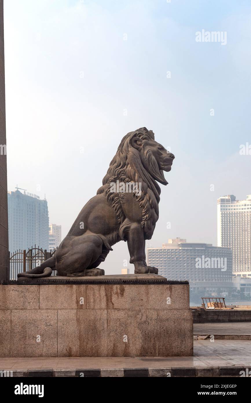 one of the famous bronze lions guarding Qasr El Nil Bridge over the River Nile in Downtown Cairo ...