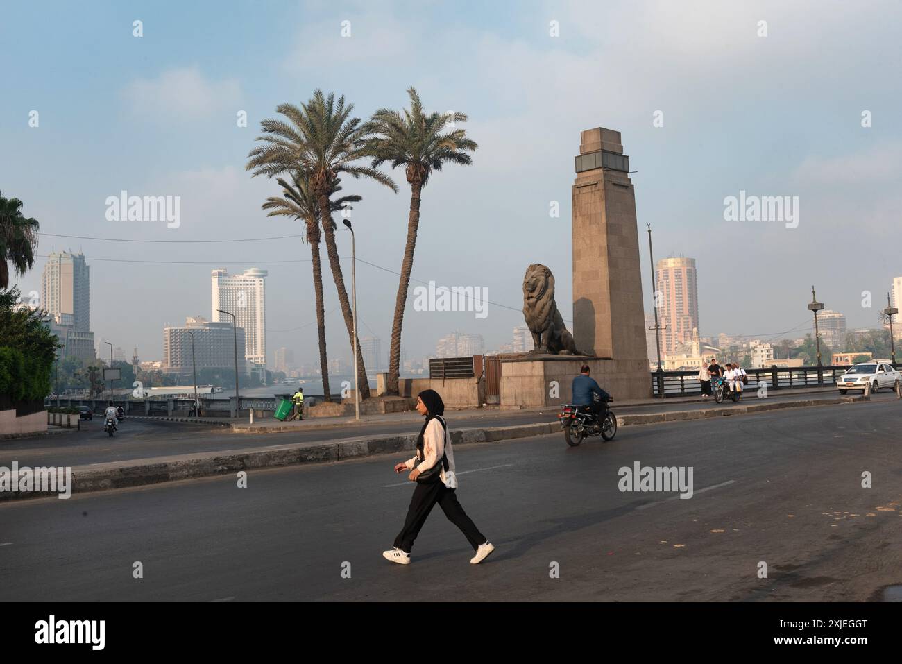 Cairo, Egypt. July 1st 2024 A young muslim Egyptian woman crosses Qasr El Nile Bridge in the ...