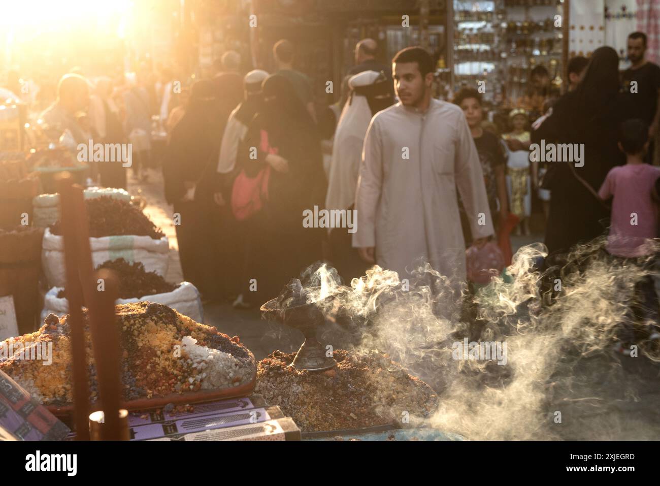Cairo, Egypt. July 2nd 2024 Smoke from burning incense in a busy market ...