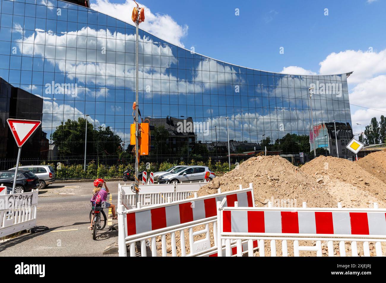 construction site barriers on Bonner street, glass facade of an office ...
