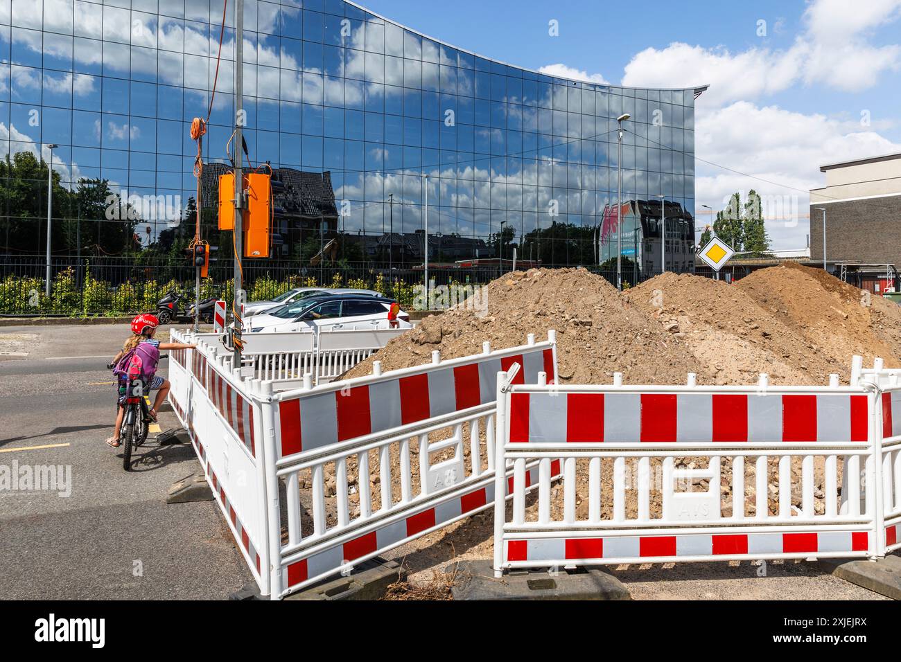 construction site barriers on Bonner street, glass facade of an office ...