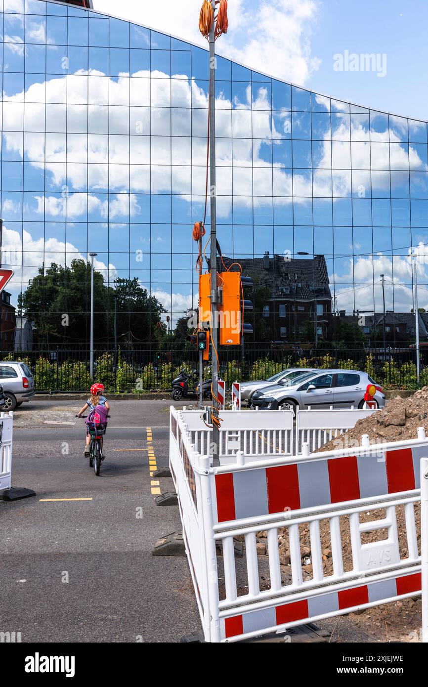 construction site barriers on Bonner street, glass facade of an office ...