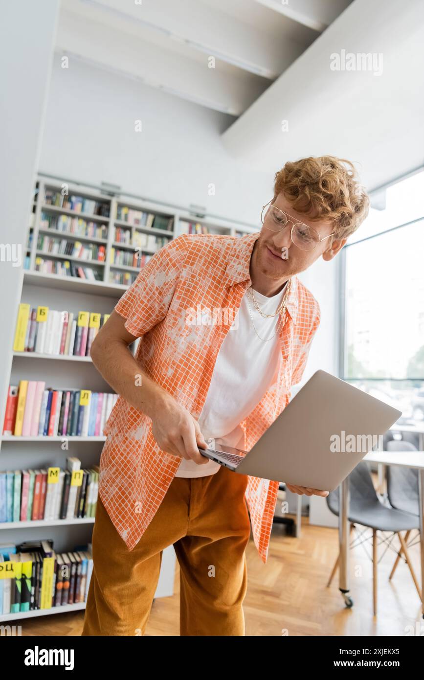 Attractive smart man in library hi-res stock photography and images - Alamy