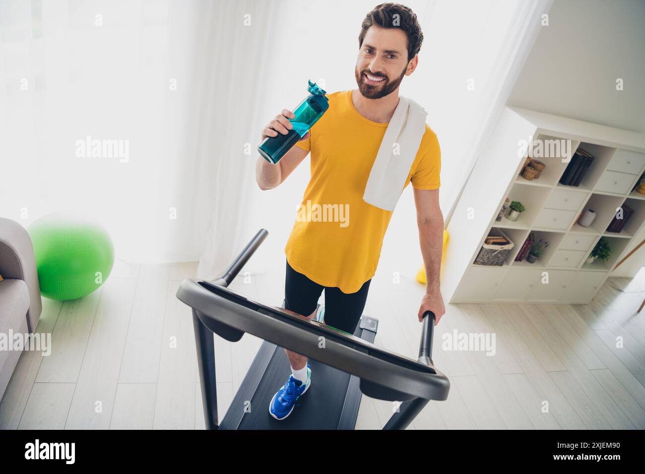 Photo of cheerful glad athletic strong man physical exercises running ...
