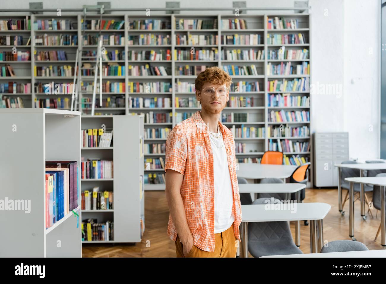 A man absorbed in books at a library Stock Photo - Alamy