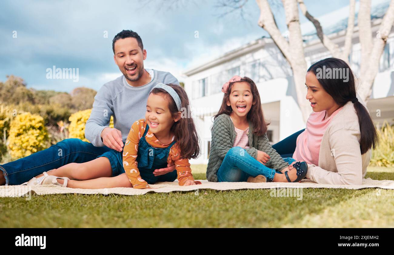 Picnic, laughing and happy parents relax, play or enjoy outdoor bonding ...
