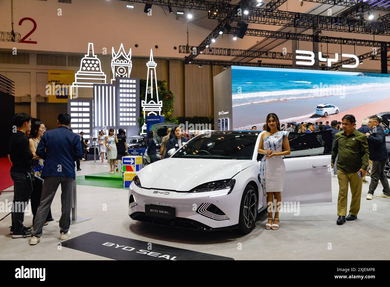 Tangerang, Indonesia. 18th July, 2024. Visitors look at vehicles displayed at the booth of ...