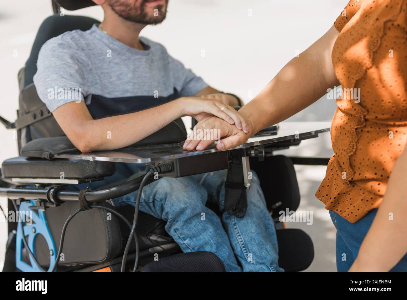 Gentle touch of married couple hands, of man with physical impairment ...