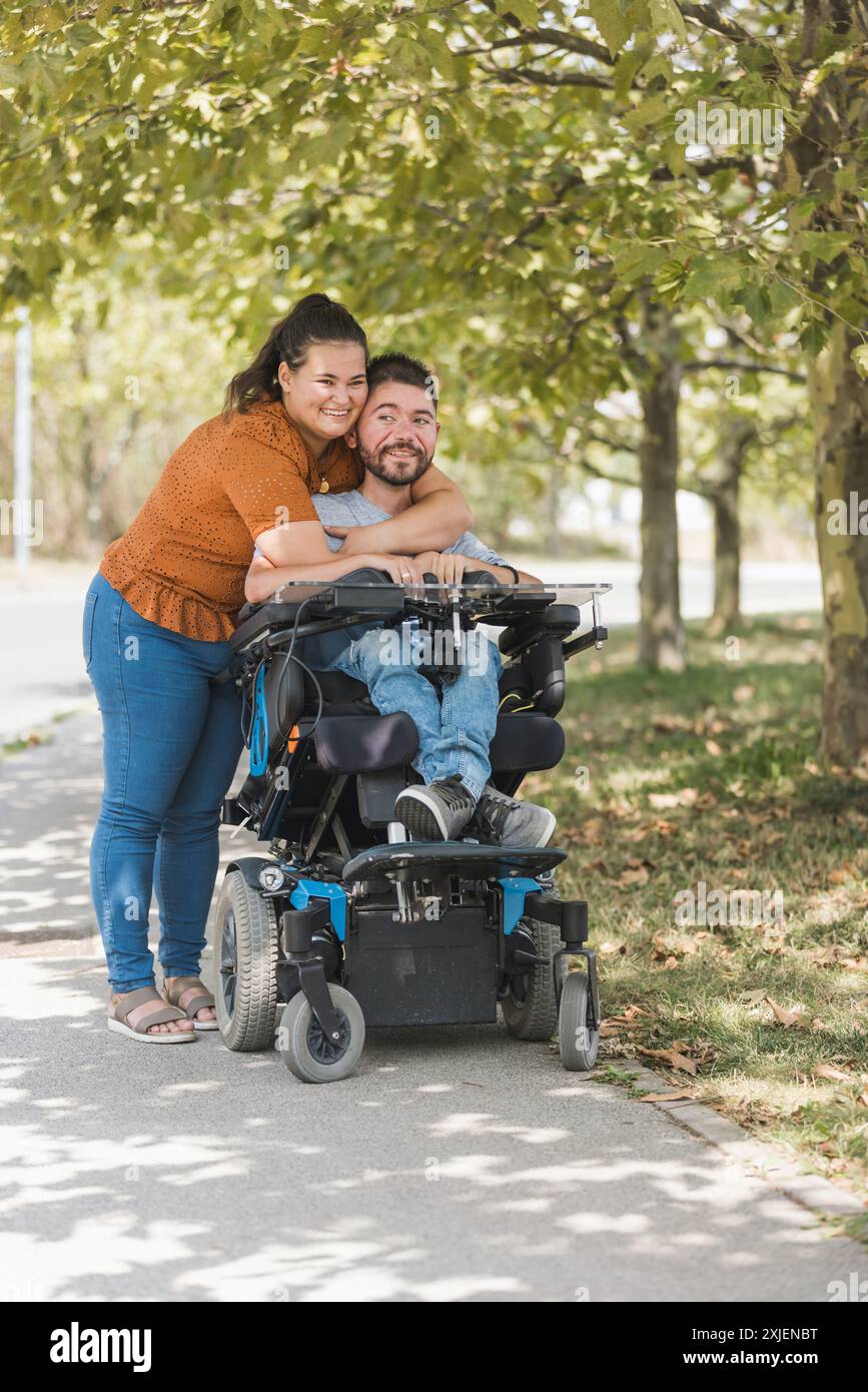 Moment of tenderness, a woman kissing and hugging her husband with a ...