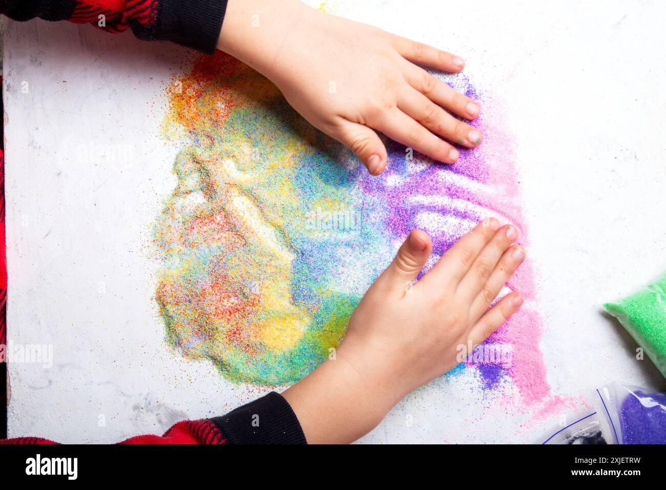 Childs hands crafting a colorful blend, rainbow colors. Motor skills ...