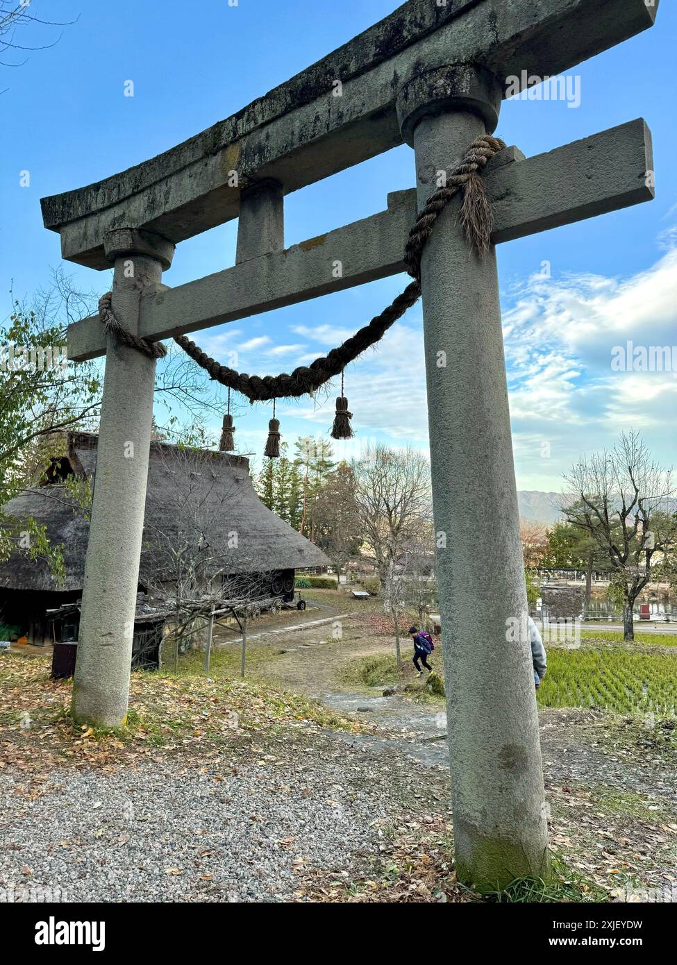 Traditional Japanese torii gate in a serene rural setting with a ...