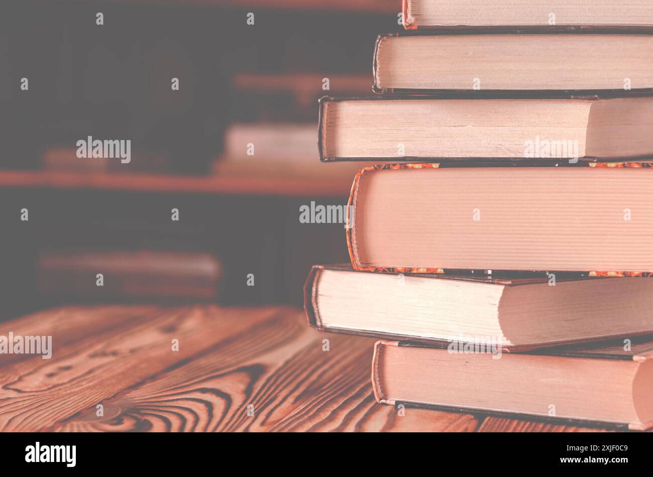 Books. Old books stand on a wooden shelf against the background of ...