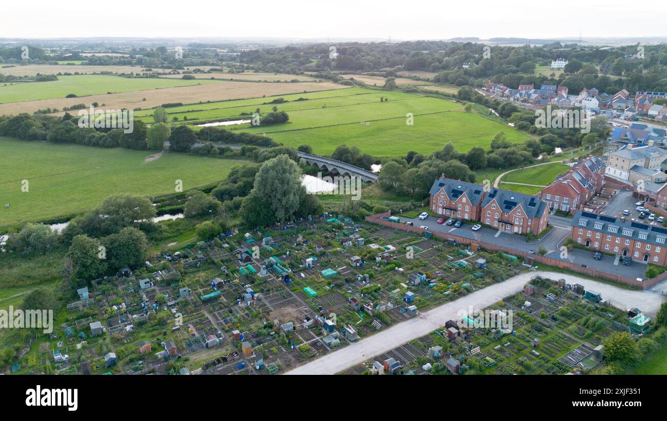 aerial view of allotments, new build houses and distant country house ...