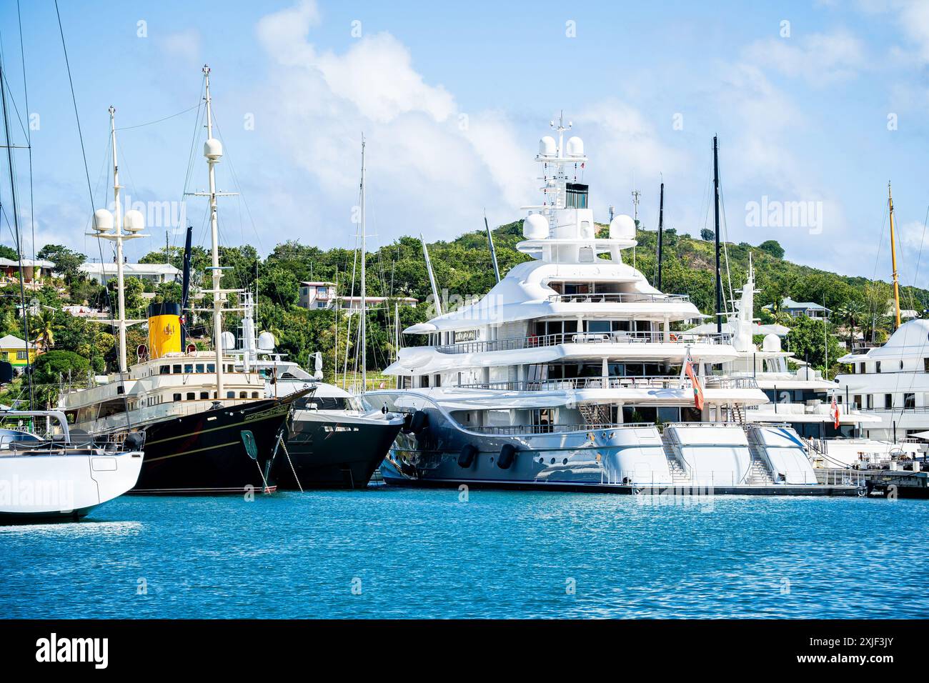 Several beautiful and spotless mega and superyachts at dock in English ...