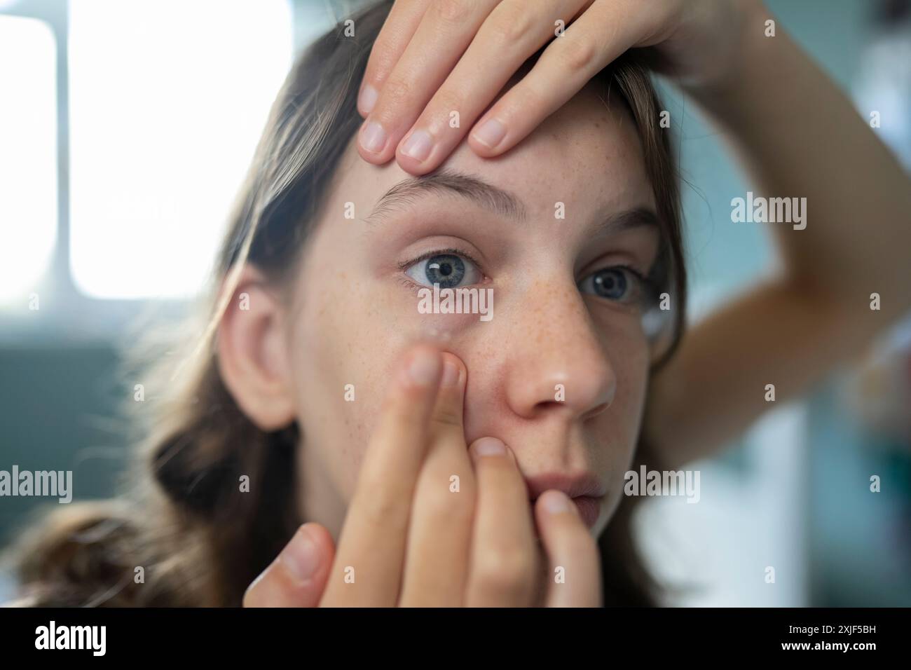 Close Up Of Teenage Girl At Home Putting Disposable Contact Lens Into ...