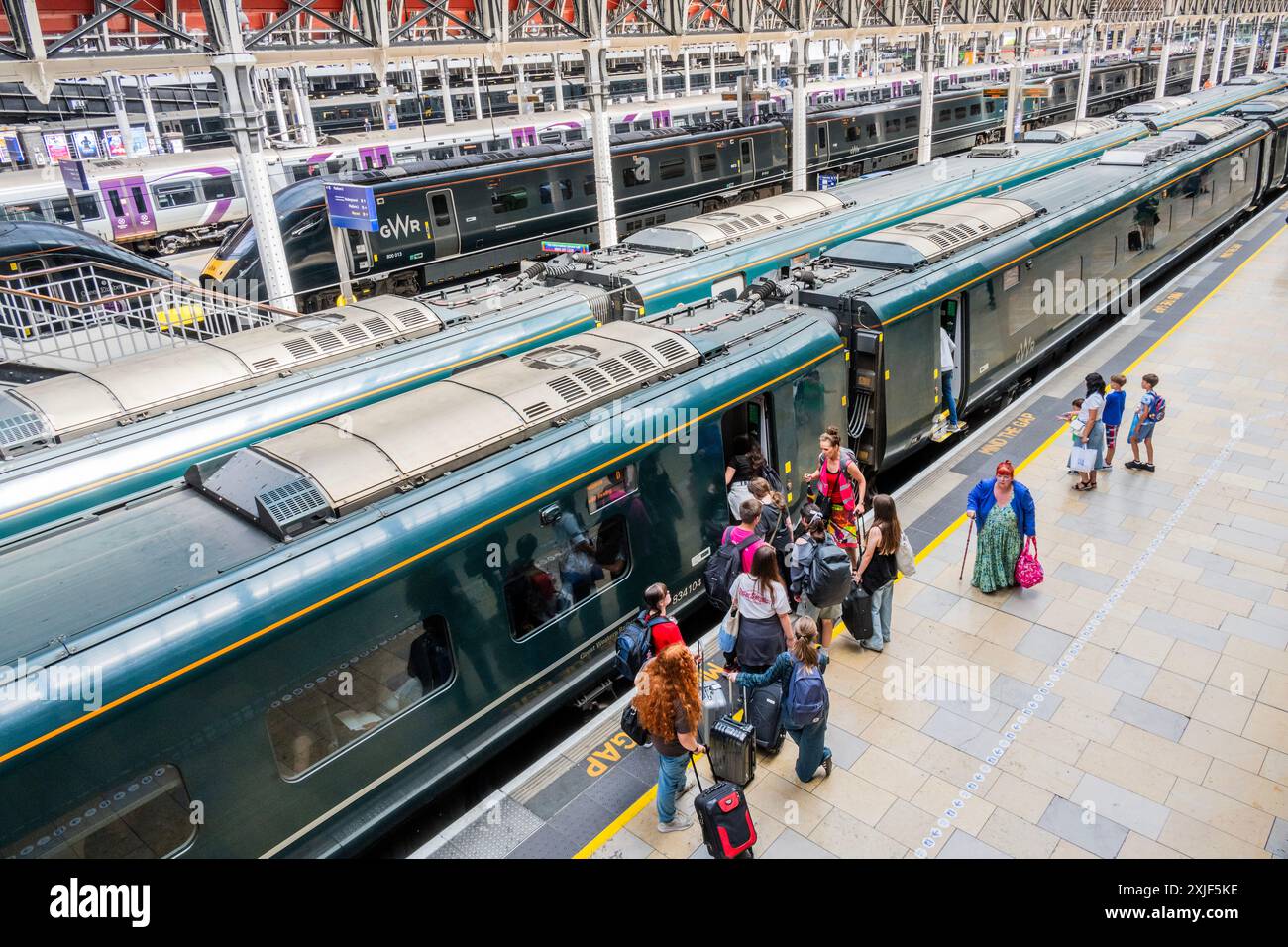 London, UK. 18th July, 2024. Passengers await or board trains at ...