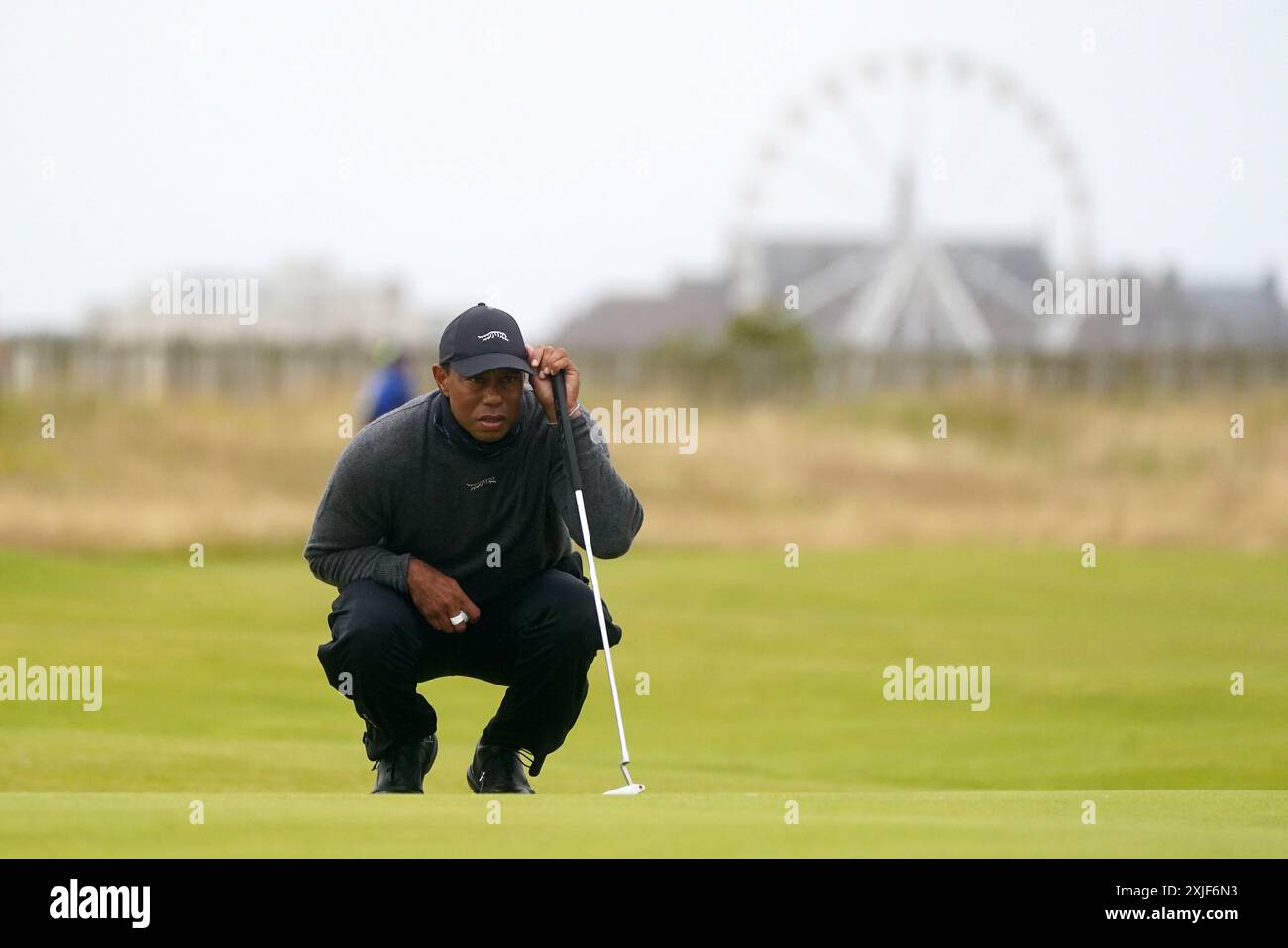 USA's Tiger Woods lines up a putt on the 1st during day one of The Open ...