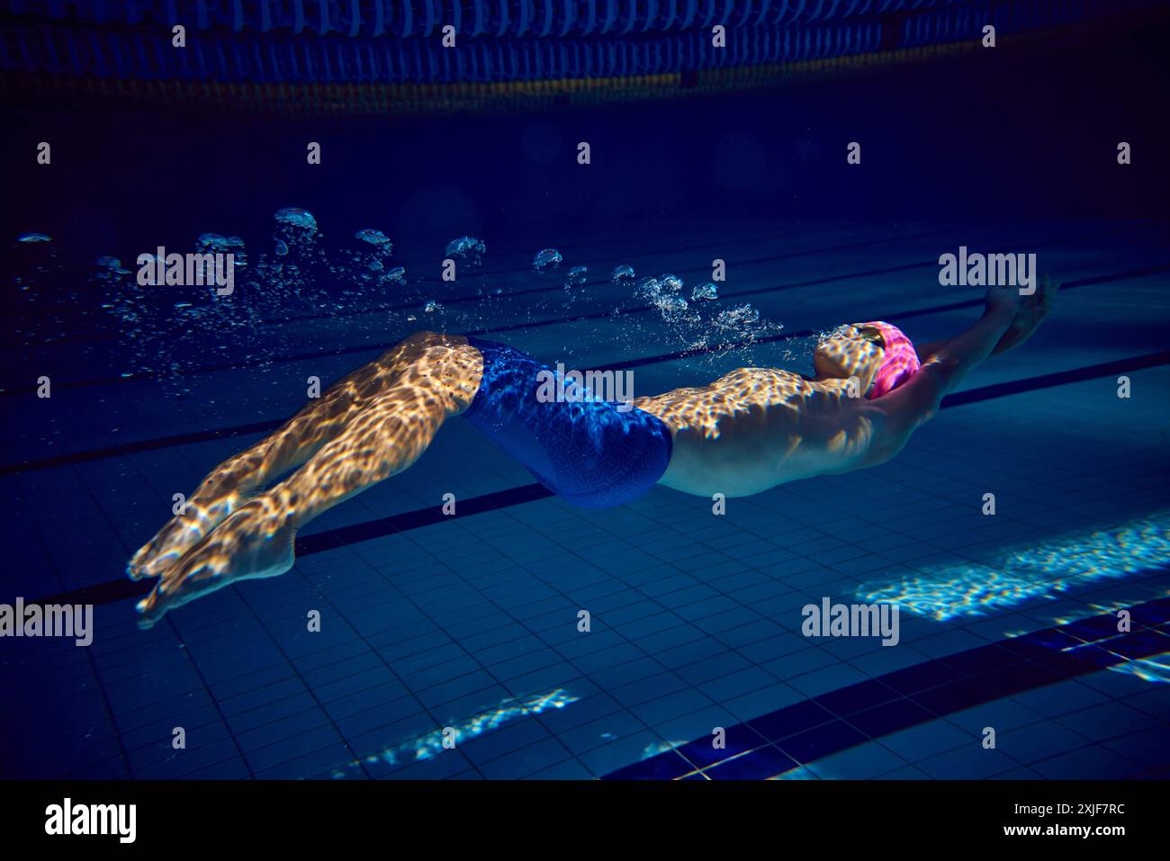 Swimmer's intense dive, highlighting his athletic physique and training ...
