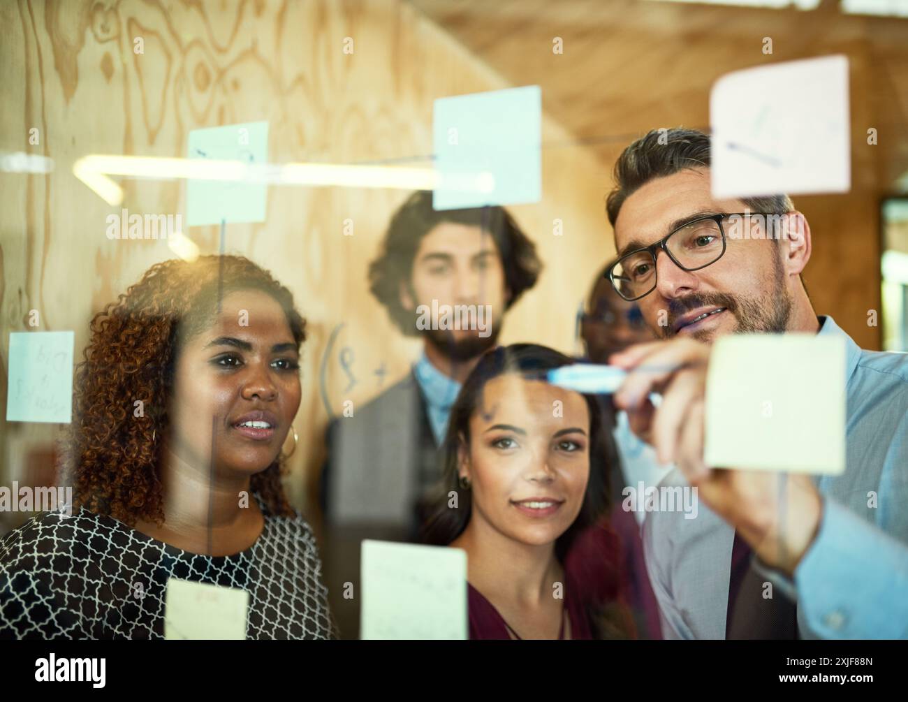 Writing, discussion and business people with glass board for ...