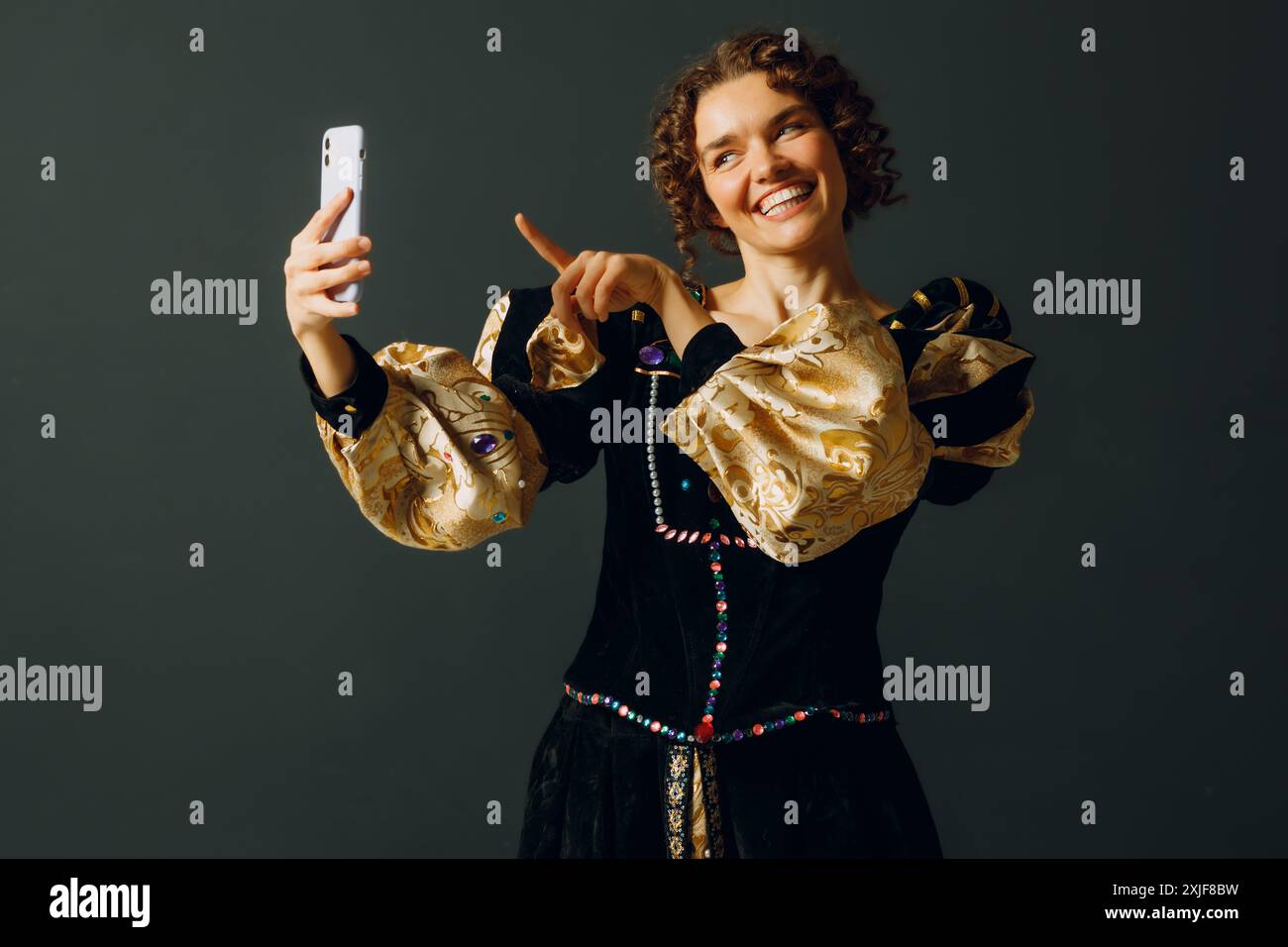Portrait of a young aristocratic woman doing photo selfie with mobile ...