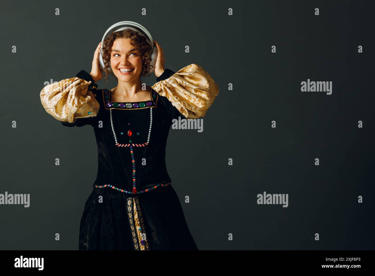Portrait of a young aristocratic woman with headphones and touching ...