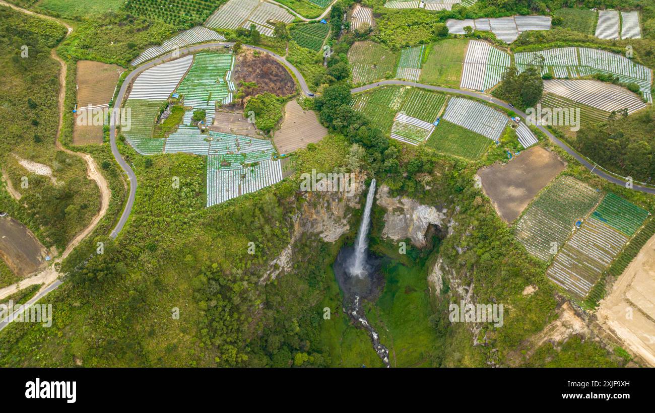 A beautiful waterfall among farmland. Sipiso Piso falls. Sumatra ...