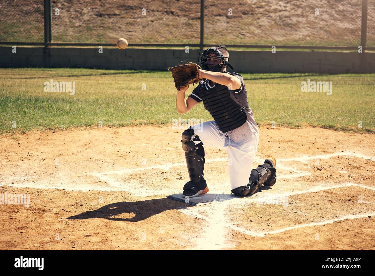 Baseball player, man and catcher with glove in game on field in helmet ...