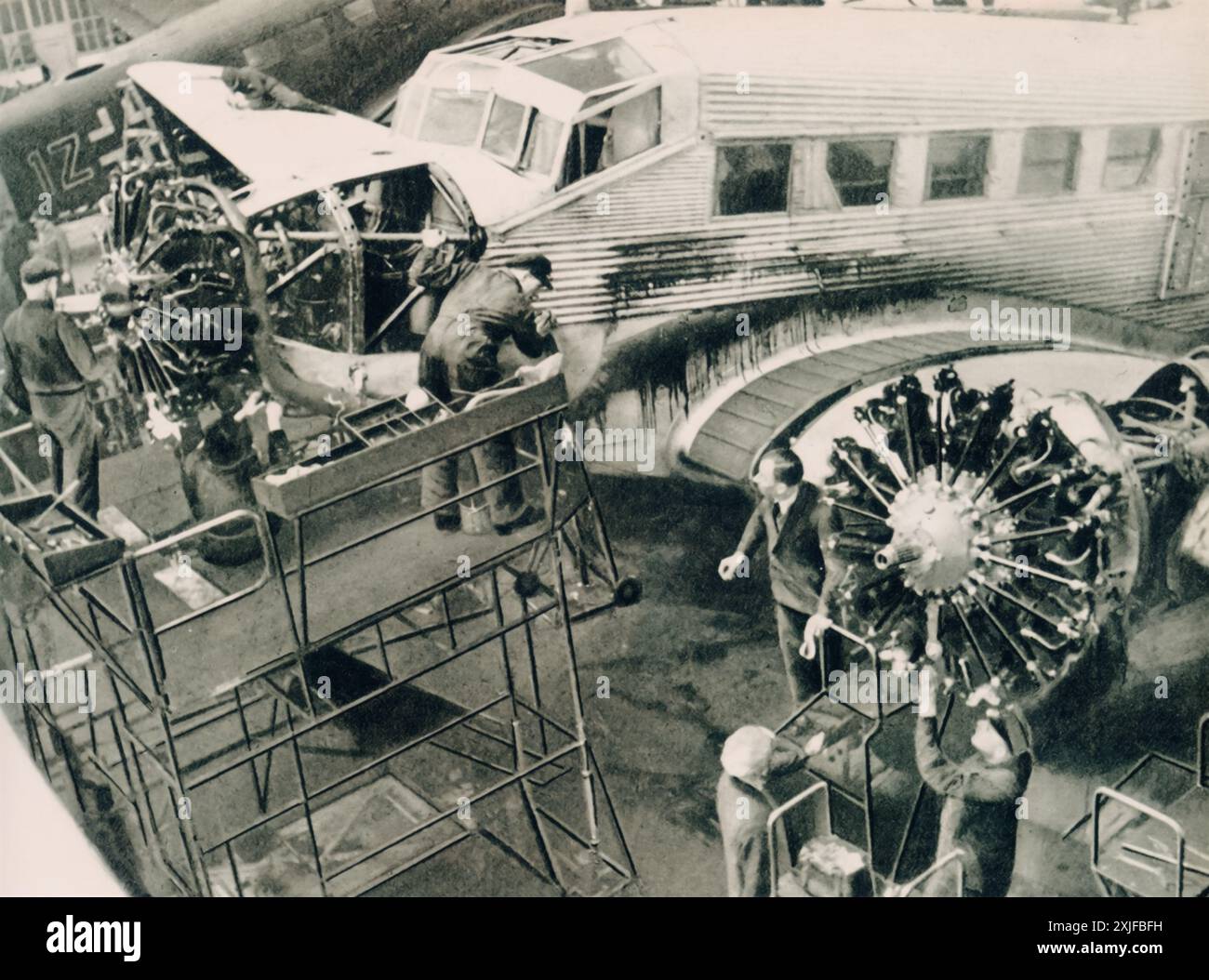 A photograph shows multiple soldiers dismantling the three engines of a ...
